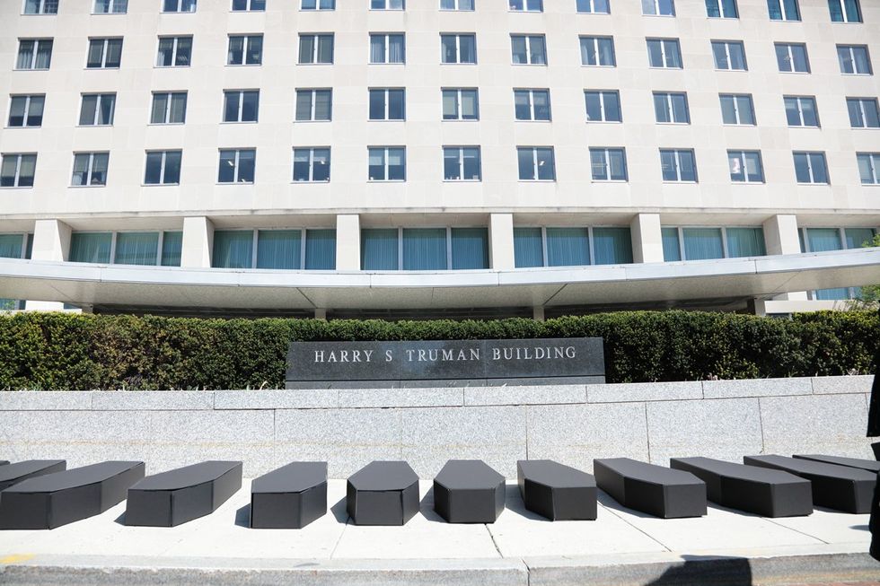 HIV and AIDS activists stack coffins. to protest PEPFAR cuts | Advocate.com