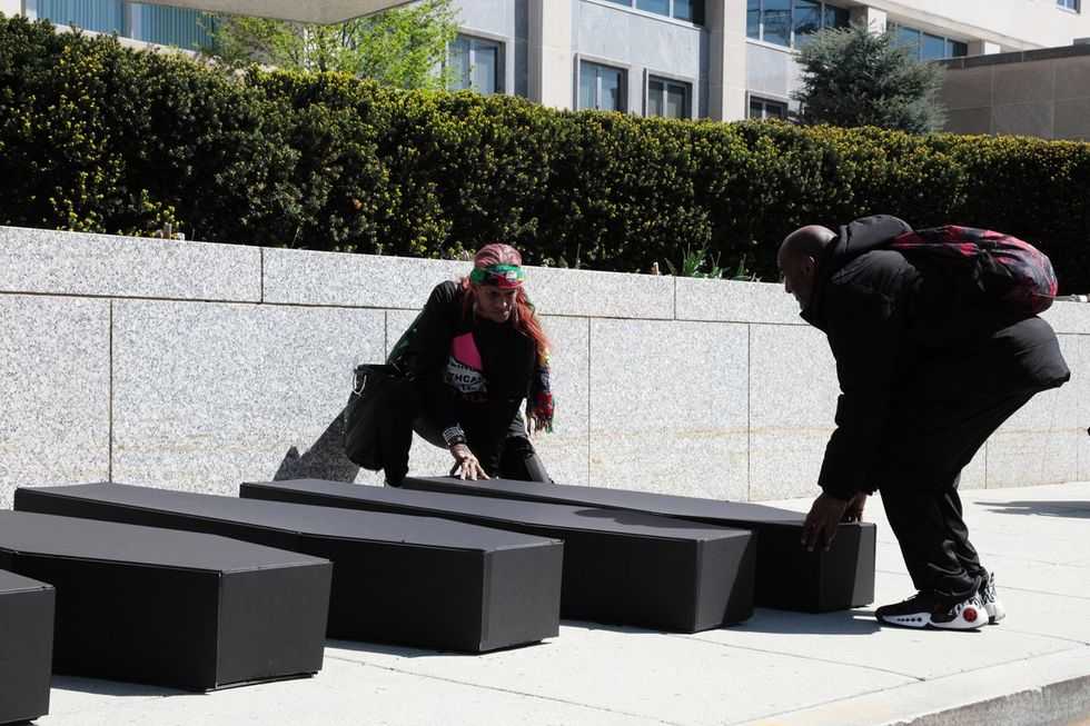 HIV and AIDS activists stack coffins. to protest PEPFAR cuts
