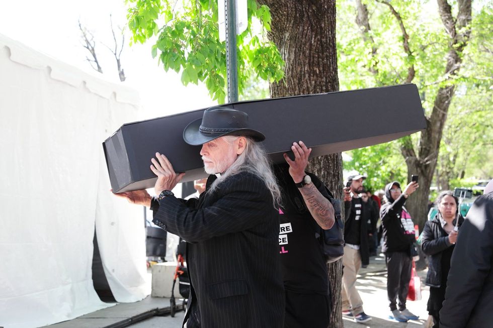 HIV and AIDS activists stack coffins. to protest PEPFAR cuts