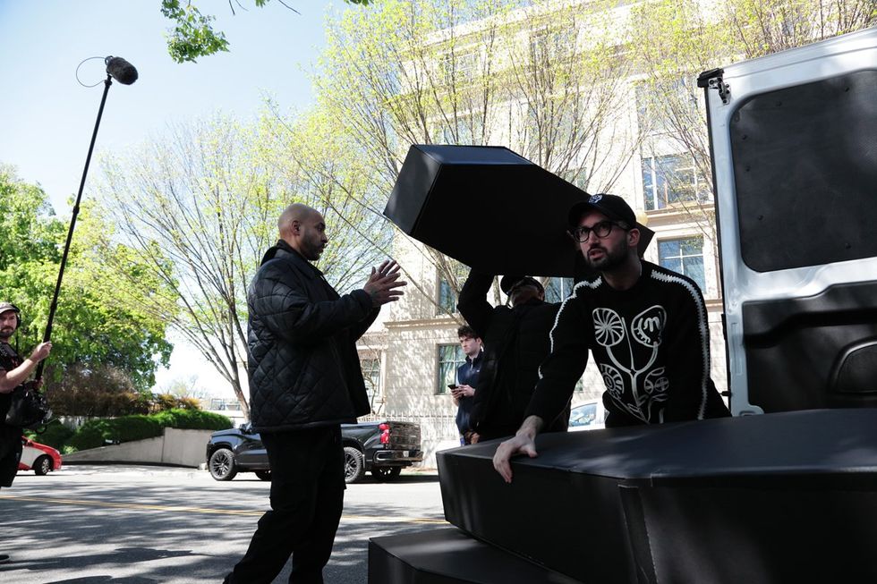 HIV and AIDS activists stack coffins. to protest PEPFAR cuts