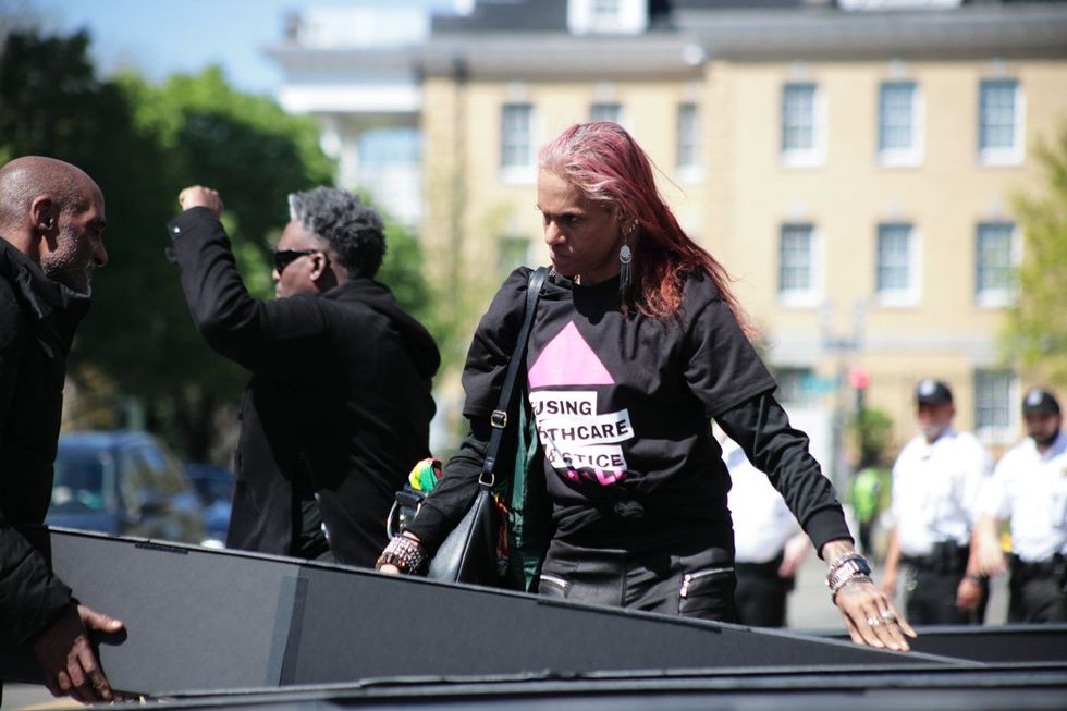 HIV and AIDS activists stack coffins. to protest PEPFAR cuts | Advocate.com