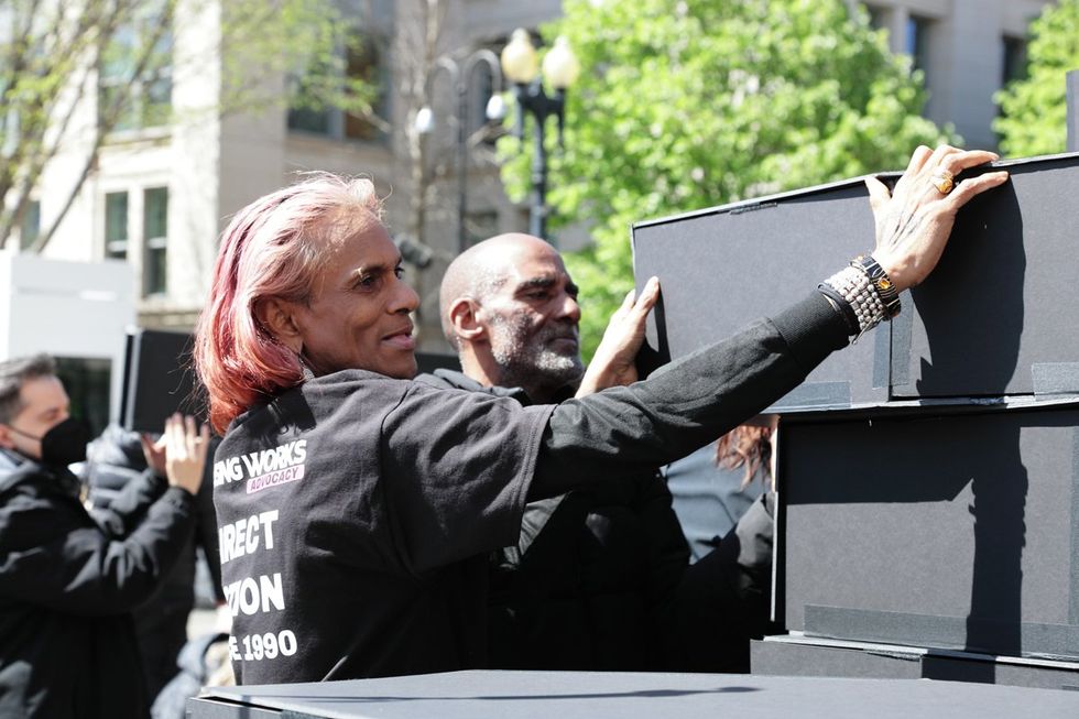 HIV and AIDS activists stack coffins. to protest PEPFAR cuts