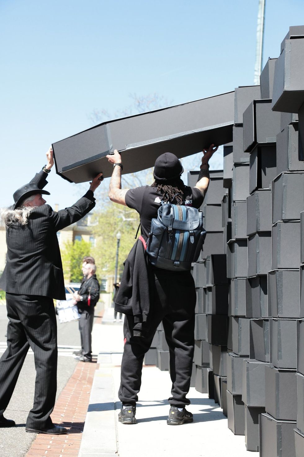 HIV and AIDS activists stack coffins. to protest PEPFAR cuts