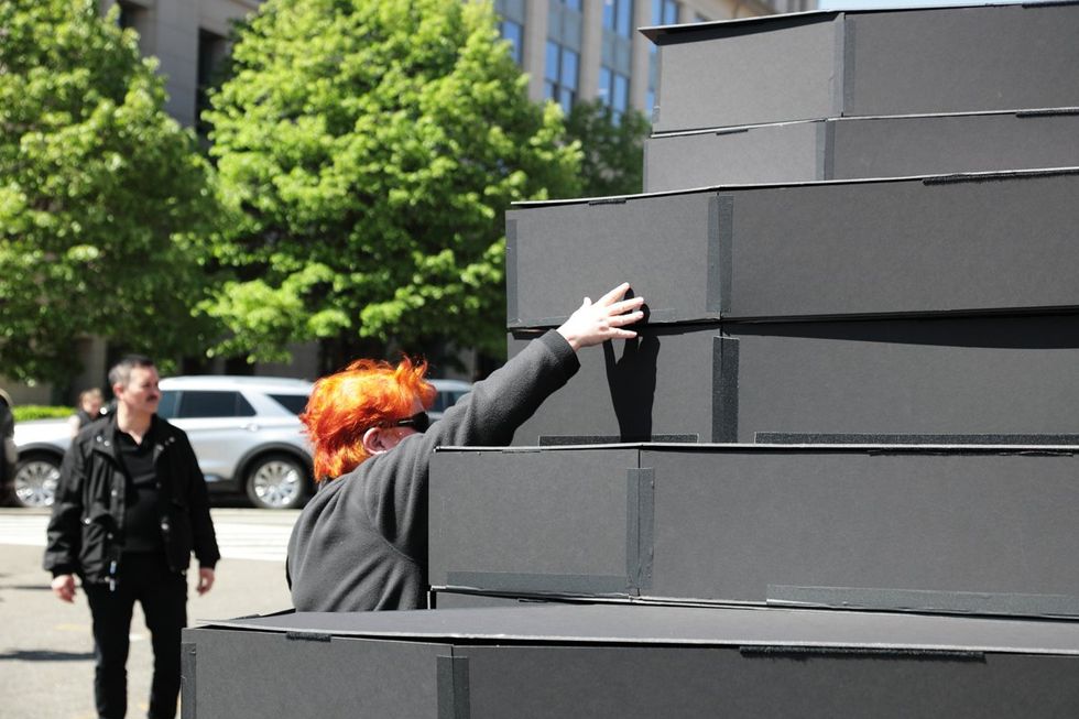 HIV and AIDS activists stack coffins. to protest PEPFAR cuts